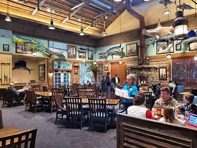 High ceilings adorned with game fish and maritime art make this space feel grand without losing its welcoming, casual charm.