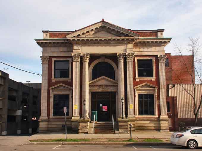 Classical columns and grand arches remind you that small cities once built public buildings like they were constructing cathedrals.