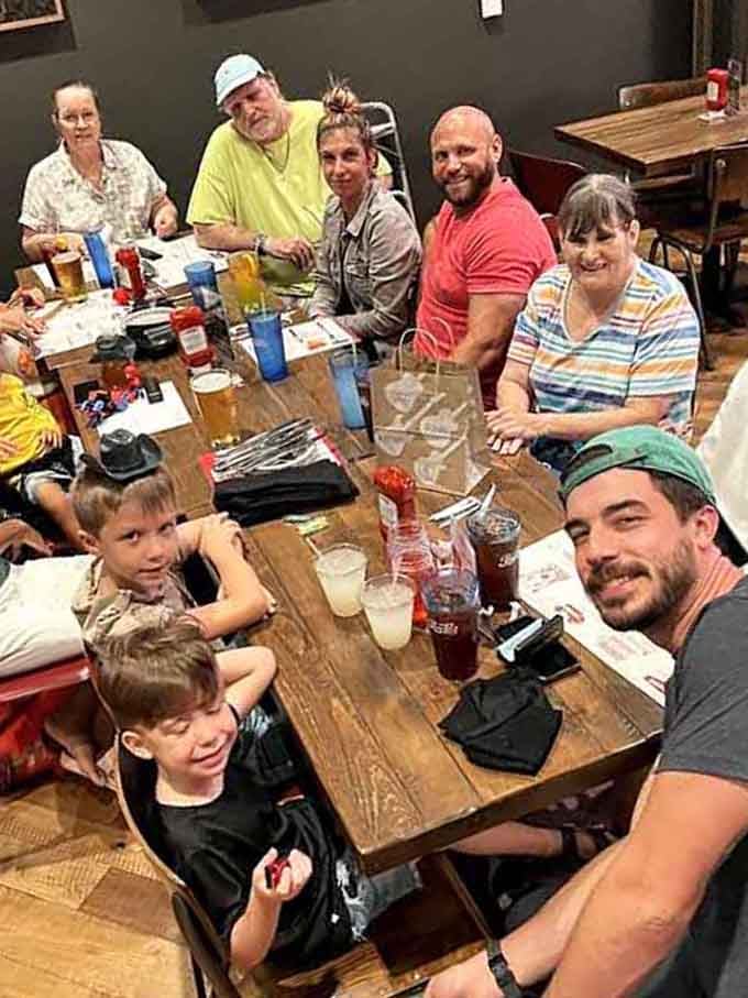 Families gathering around tables piled with barbecue: this is what community and good food look like in action.