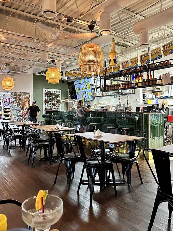 Woven pendant lights and wooden tables create a casual atmosphere where everyone feels welcome to stay awhile longer.