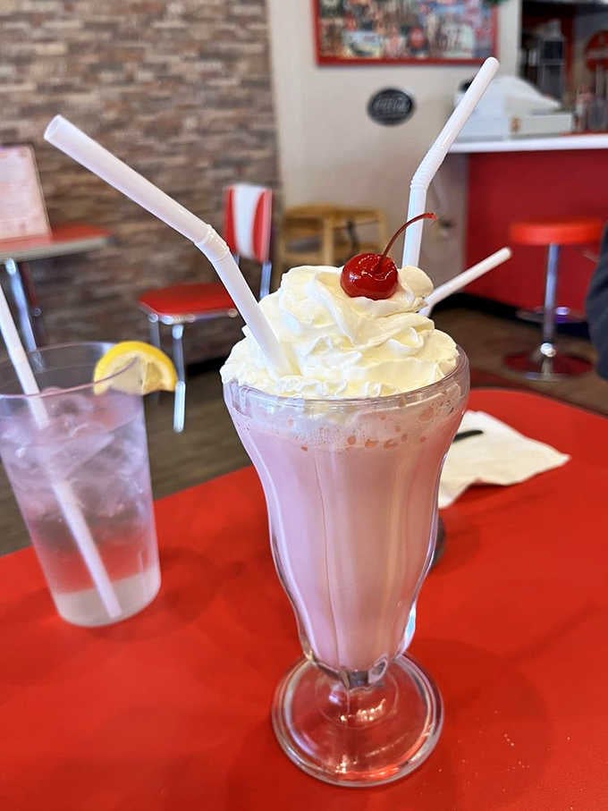 Strawberry shake perfection crowned with whipped cream, because subtlety has no place in a proper milkshake.