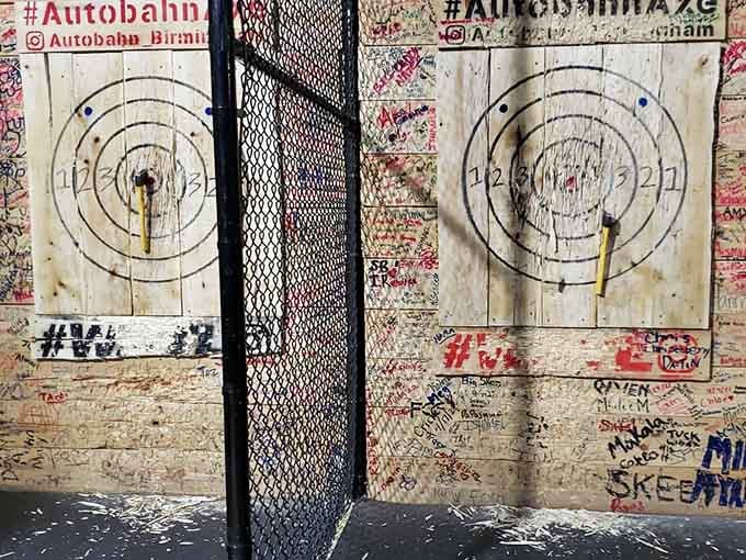 Axe throwing targets bearing the scars of a thousand throws, each one representing someone's stress leaving their body.