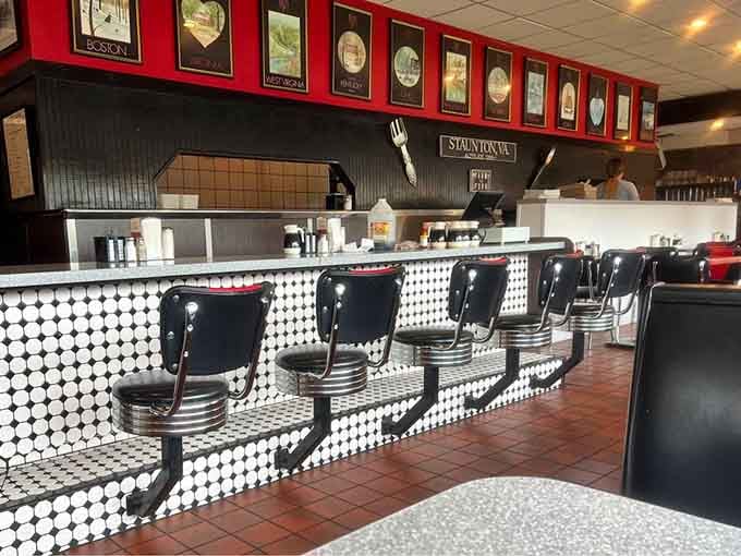 Counter seats offering front-row views of griddle magic, where pancakes flip and eggs sizzle in a breakfast ballet performance.