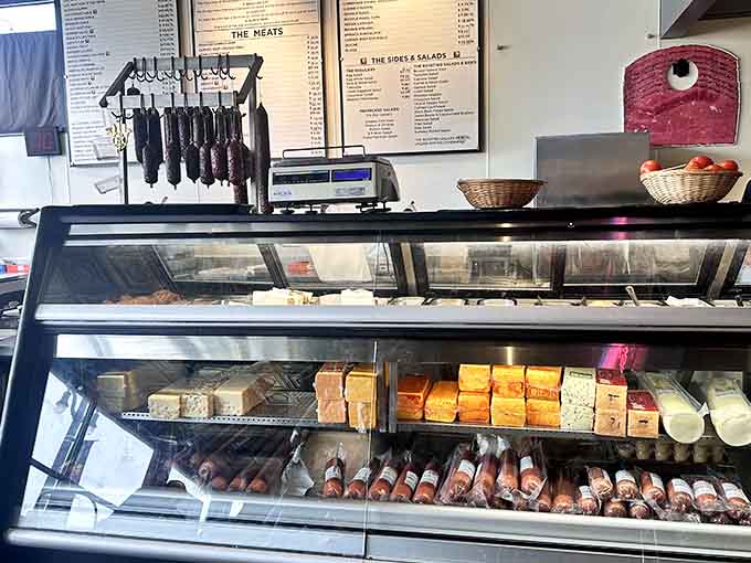 Rows of premium meats and cheeses wait patiently in the case for their moment of glory.