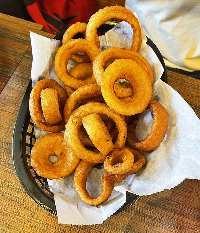 A mountain of perfectly crispy onion rings that'll make your breath interesting but your taste buds absolutely ecstatic with joy.