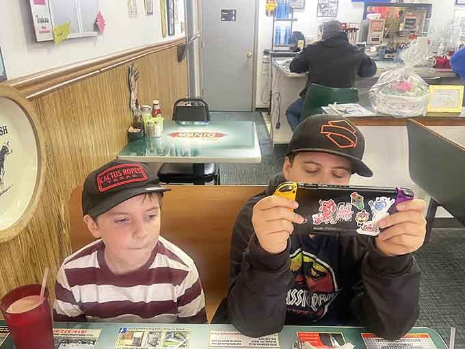 Young diners discovering that sometimes the best entertainment doesn't require WiFi, just good food and family time together.