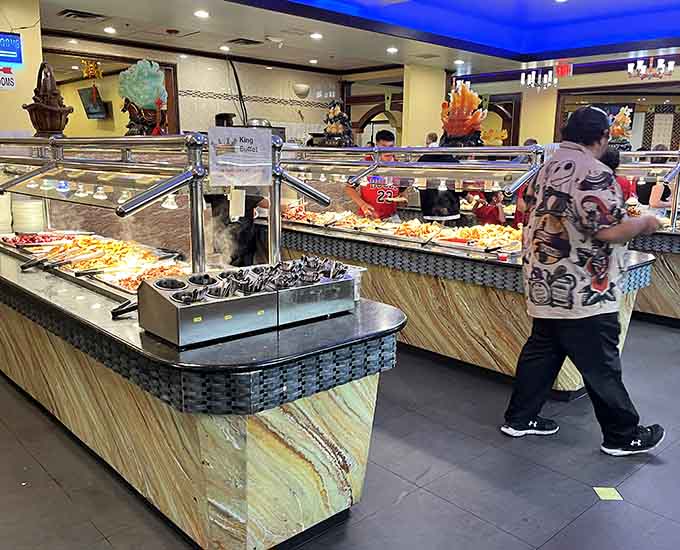 The buffet stations stretch invitingly across the dining room, a landscape of culinary possibilities awaiting your exploration.
