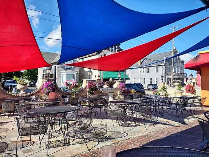 Colorful shade sails turn the patio into a festive outdoor oasis, perfect for summer evenings and people-watching downtown.