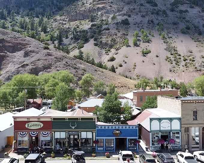 From above, the town nestles into the valley like it grew there naturally, surrounded by slopes that tell geological stories.