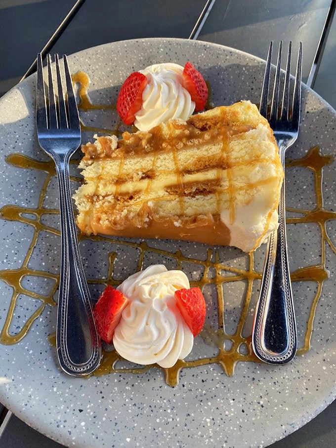 This dessert presentation with caramel drizzle and fresh strawberries is almost too pretty to eat. Almost, though.