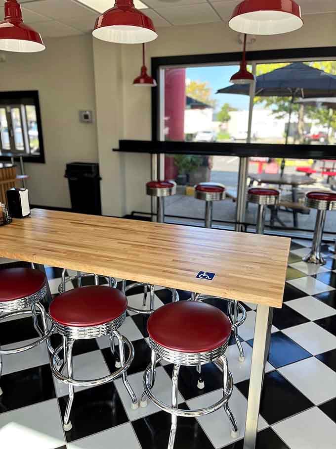 Classic diner stools meet checkered floors, creating that perfect retro atmosphere for enjoying affordable comfort food.