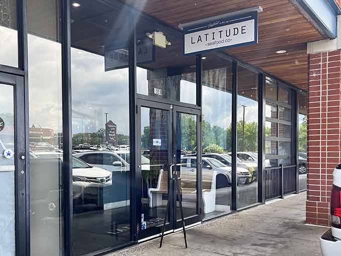 Glass-front entrance welcomes diners into a bright, contemporary space that feels both upscale and refreshingly approachable for everyone.