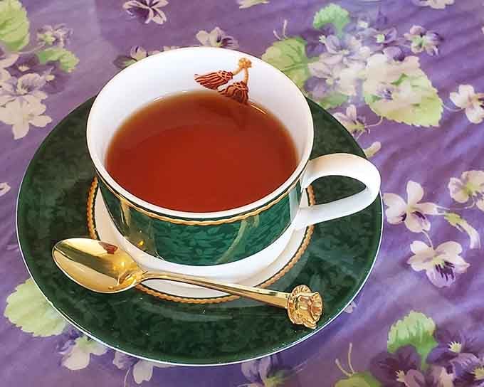 Hot tea served in an emerald green cup with gold accents makes you feel fancy without even trying.