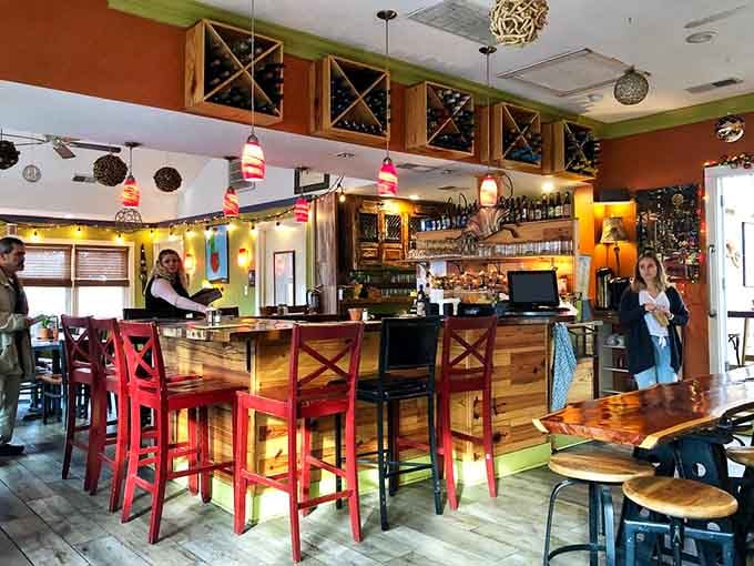 The bar area showcases beautiful woodwork and colorful stools, inviting you to settle in for a leisurely meal.