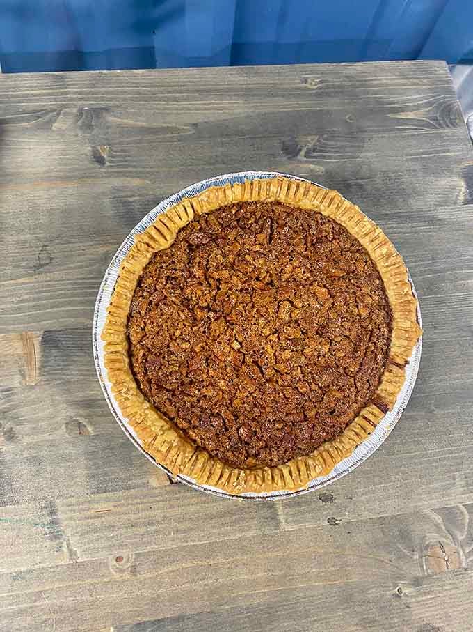 That pecan pie sitting there with its perfectly crackled top is the sweet ending every great barbecue story deserves, like the final note in a beautiful song.
