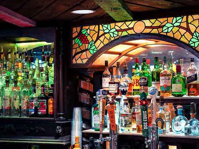 The bar glows like a treasure chest, promising liquid courage for whatever character serves your dinner tonight.