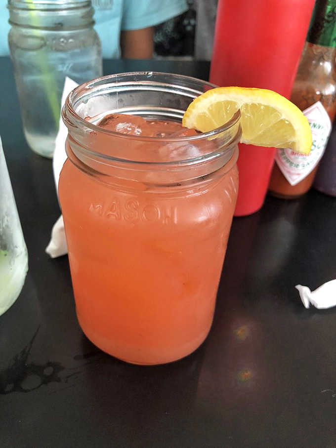 Fresh lemonade in a mason jar with a lemon wedge: simple pleasures done exactly the right way.