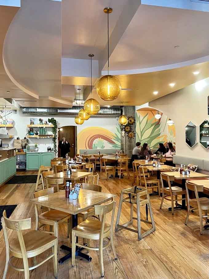 Light wood tables and chairs create a casual dining space where you can linger over coffee without feeling rushed or out of place.