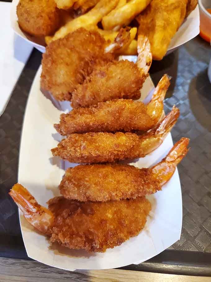 Butterflied shrimp lined up like golden soldiers, ready to march straight into your belly without resistance.