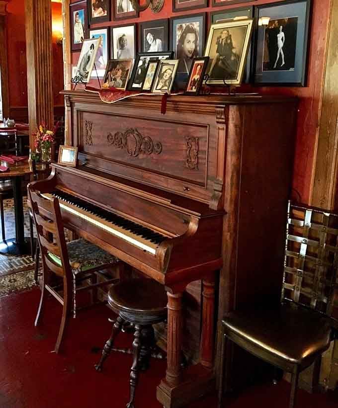 An antique piano surrounded by vintage photographs creates ambiance that no decorator could ever fake properly.