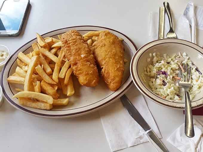 Golden fried fish with crispy fries and coleslaw delivers comfort food that tastes like a warm Minnesota hug.