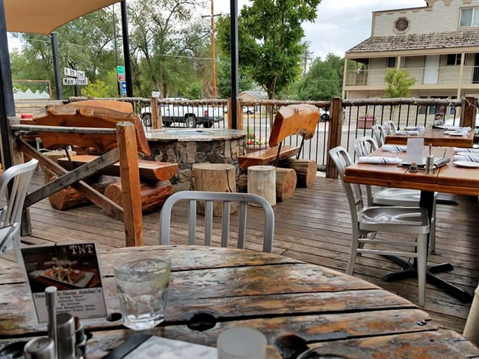 The outdoor patio features creative seating and mountain views, perfect for Colorado's beautiful dining weather.