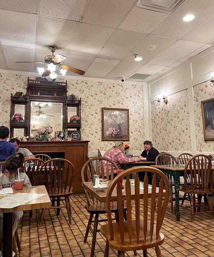 Ceiling fans and floral wallpaper create an atmosphere that's refreshingly unconcerned with being trendy or hip.