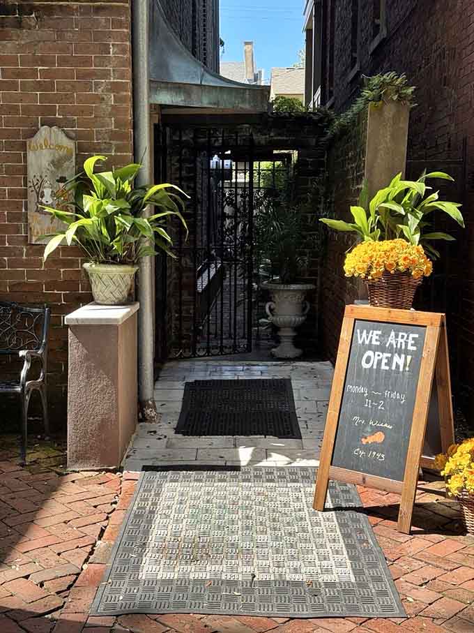 The side entrance welcomes guests through a charming brick courtyard, setting the stage for the communal feast awaiting inside.