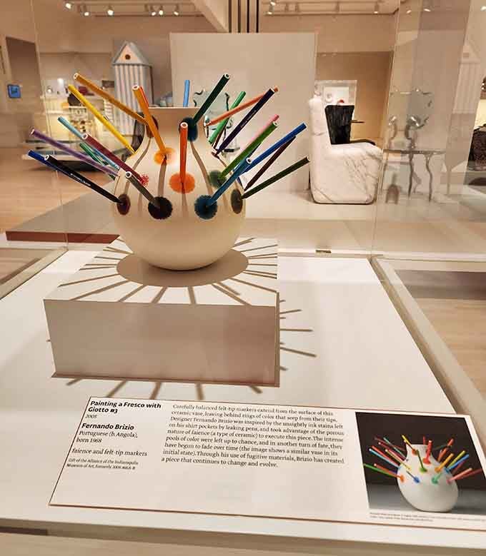 Colorful glass rods explode from a ceramic base like a frozen fountain of artistic expression and whimsy.