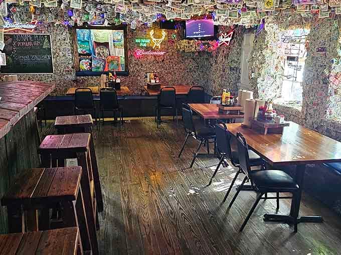 Wooden tables and chairs surrounded by currency-covered walls create an atmosphere that's equal parts quirky and completely charming.
