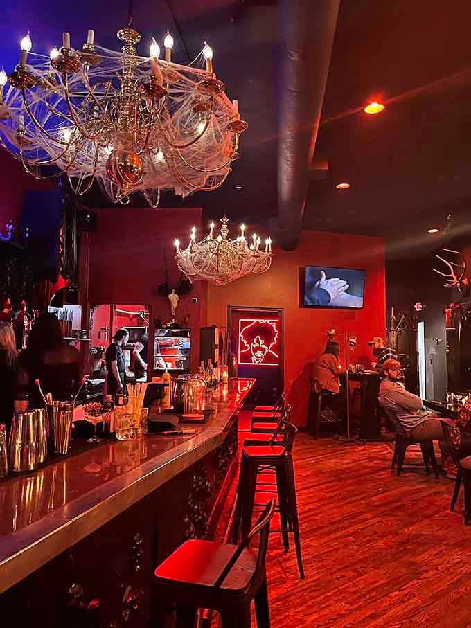 The bar glows with colored lights that make every bottle look like it contains magical potions.