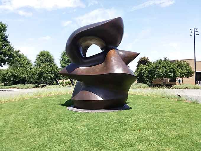 This abstract bronze sculpture twists and turns with organic grace, looking like it grew naturally from the museum's manicured lawn.