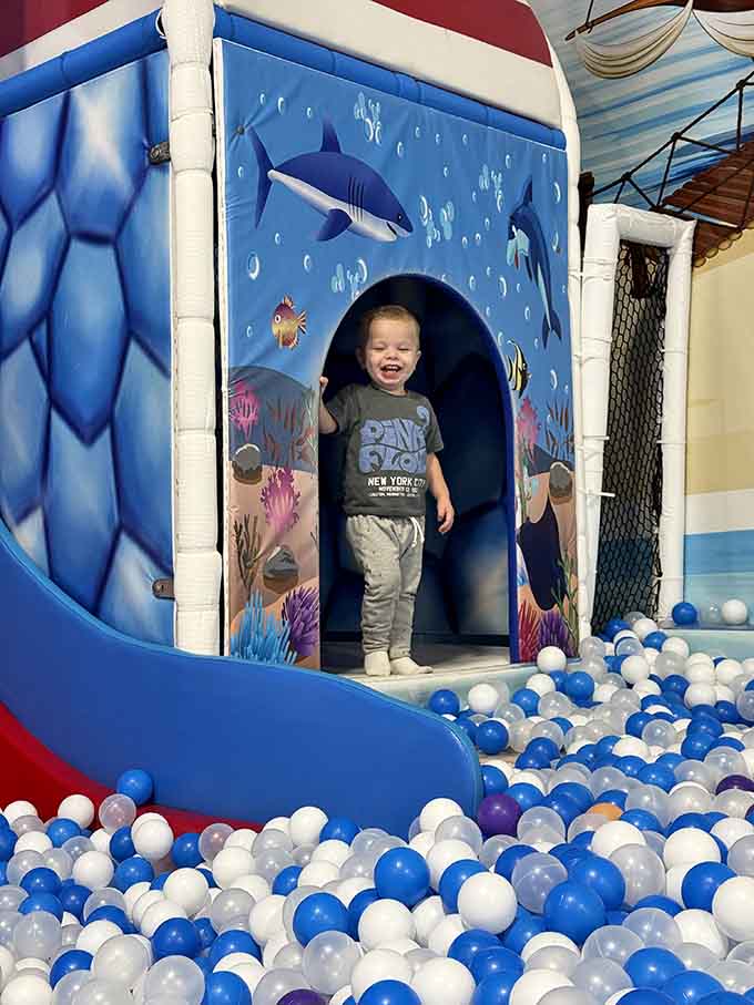 Emerging from the shark-themed structure with that triumphant grin means the adventure was absolutely worth every second.