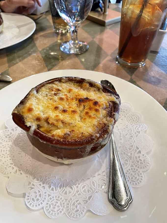 French onion soup bubbling under a golden cheese crust, ready to warm your soul one spoonful at a time.