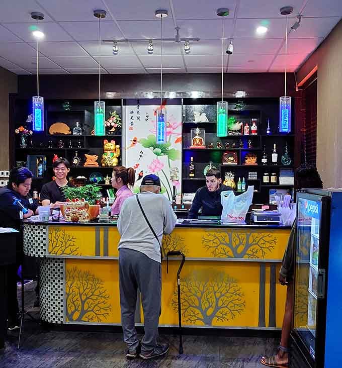 The cheerful payment counter where friendly staff greet you before unleashing you into a world of unlimited culinary possibilities ahead.