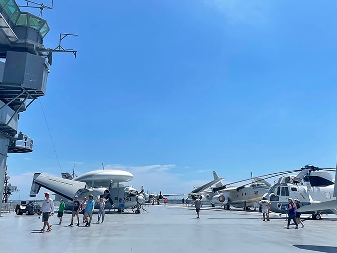 Visitors wander among legends of naval aviation, probably resisting the urge to make airplane noises while nobody's looking.