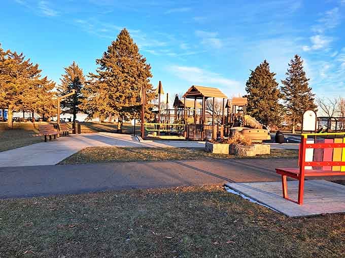 Golden hour transforms this playground into a Norman Rockwell painting, where kids play in the shadow of legends.