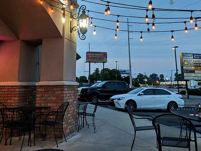 The parking lot at dusk, where cars rest while their owners wage war against gravity-defying pizza slices.