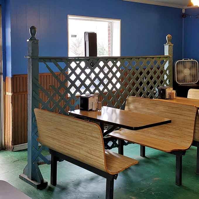 Lattice dividers and booth seating create cozy corners perfect for demolishing burgers without judgment from strangers.