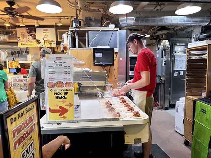 Industrial fixtures and exposed ductwork frame the action like a stage where pastry dreams come true every single morning.