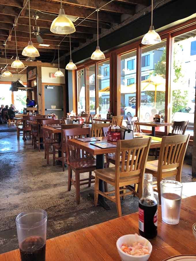 Simple wooden tables and pendant lights create a comfortable space where barbecue takes center stage beautifully.