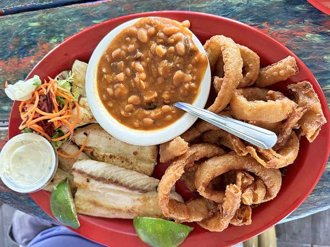 Fried cobia strips with onion rings and beans create a hearty platter that sticks to your ribs wonderfully.