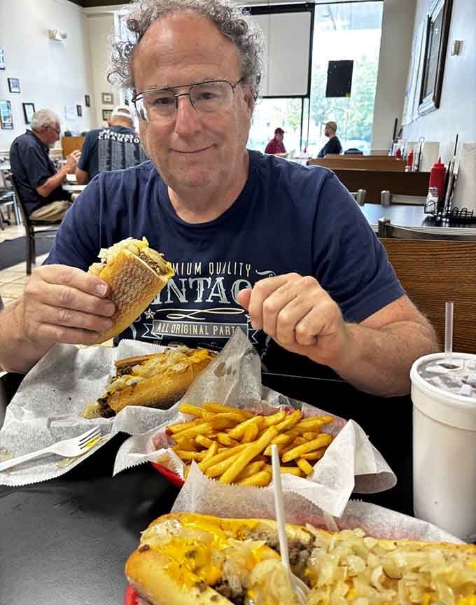 The look of someone who's just realized that finishing this meal might require a strategic nap afterward.