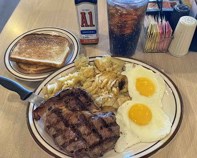 Steak and eggs with hash browns and toast, the kind of plate that makes you grateful for elastic waistbands.