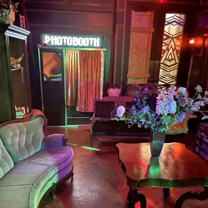 A photobooth tucked among velvet furniture, because memories of your gothic adventure deserve proper documentation and Instagram glory.