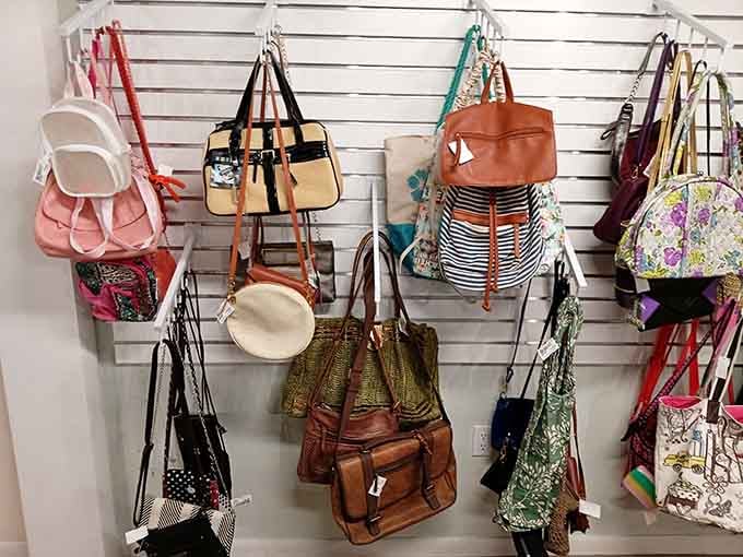 Handbags hanging like fashion possibilities, each one ready to carry your essentials with pre-loved character and charm.