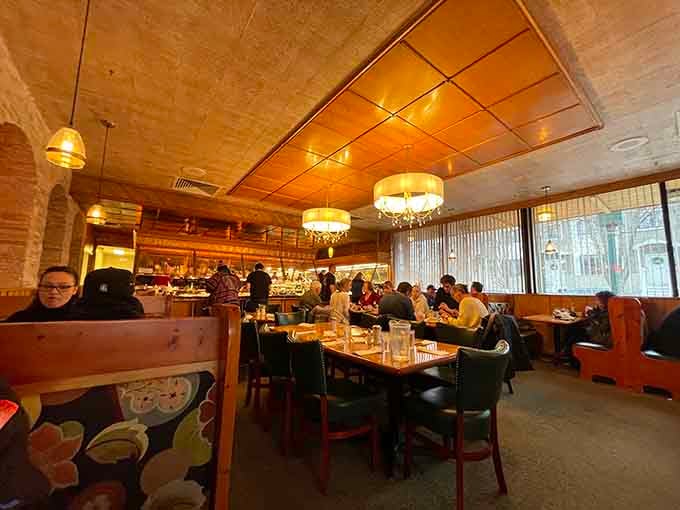 Fellow diners engaged in the serious business of strategic buffet planning and enthusiastic plate loading throughout the room.