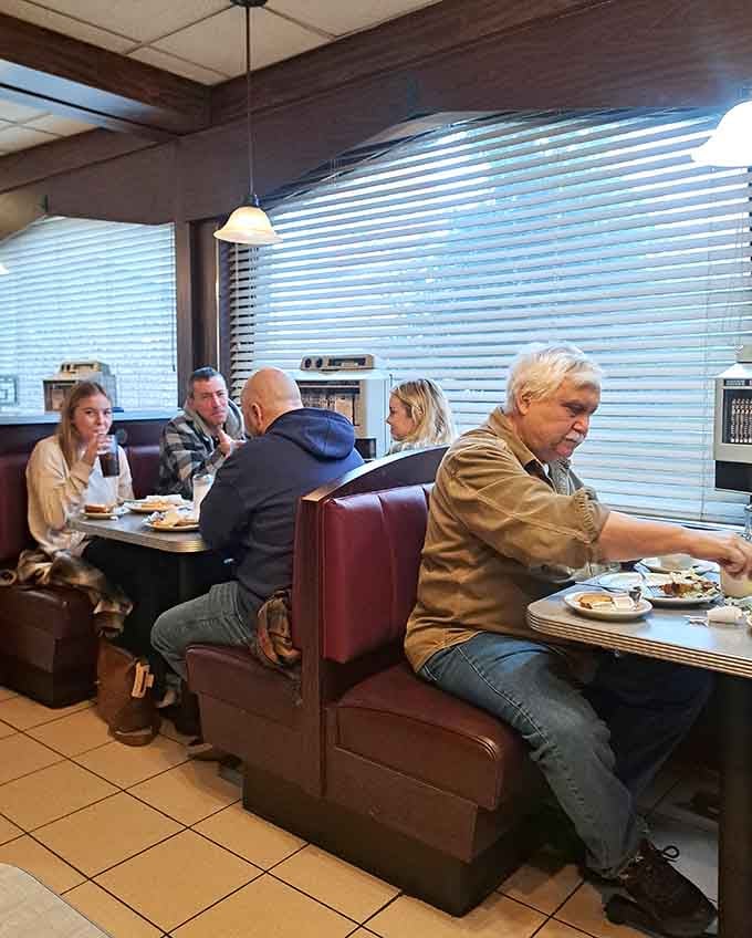 Real people enjoying real food in real booths, this is what authentic dining culture looks like in action.