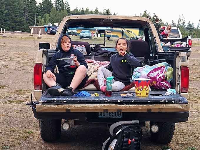 These young moviegoers have mastered the art of tailgate seating, popcorn optional but highly recommended.