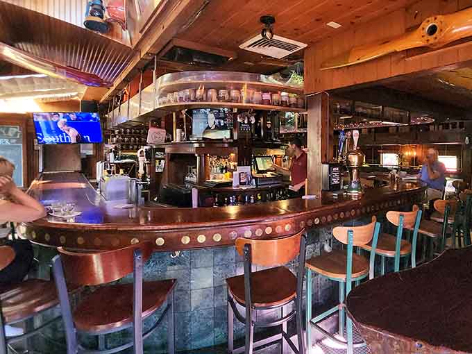 The bar area gleams with copper accents and personality, inviting you to pull up a stool and stay awhile.